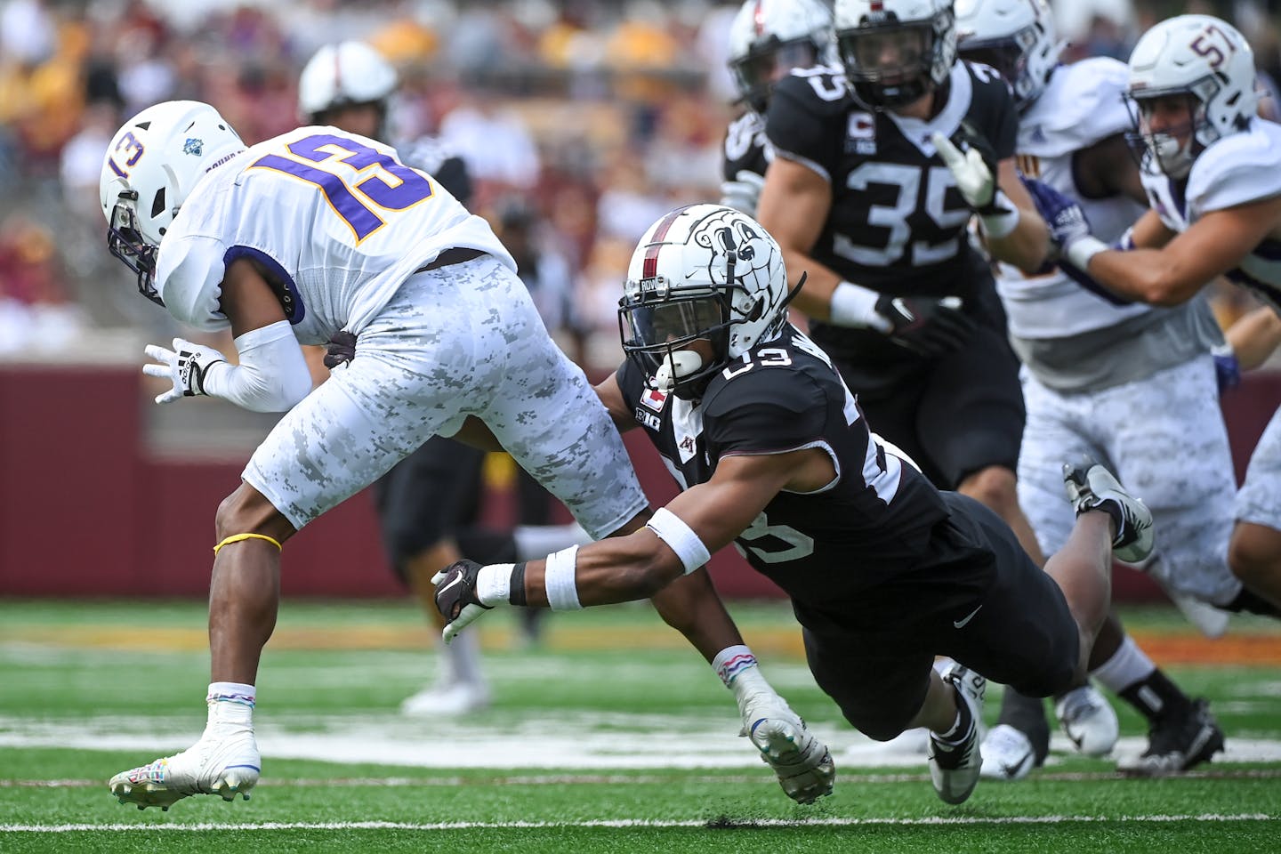 Gophers defensive backs Jordan Howden and Terell Smith trying to stand ...
