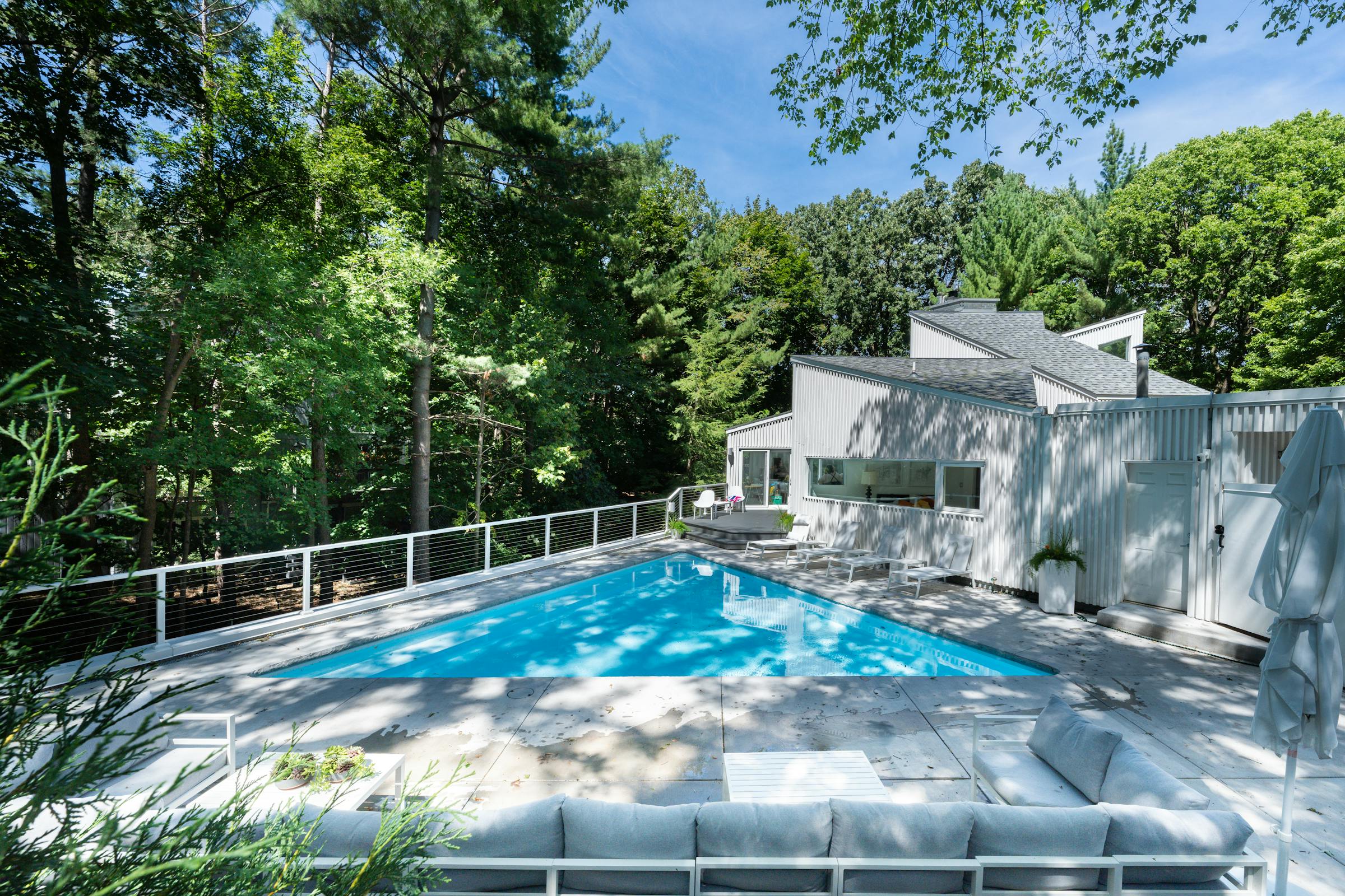 'Fun' triangular pool transforms backyard of star-shaped Minneapolis house