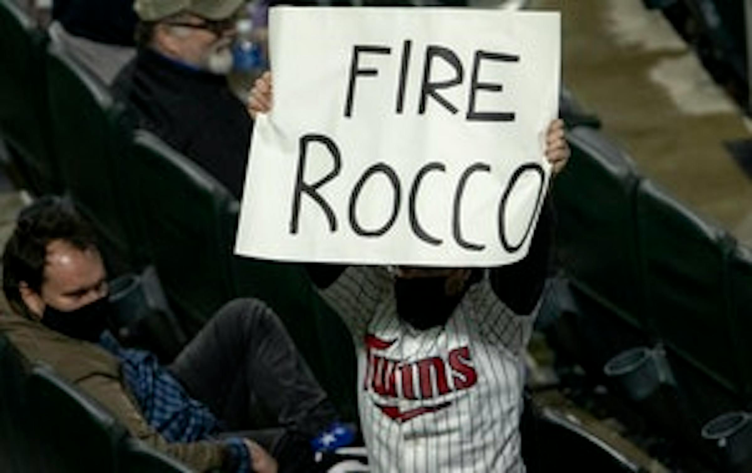 Fan with 'Fire Rocco' sign at Target Field explains his frustration